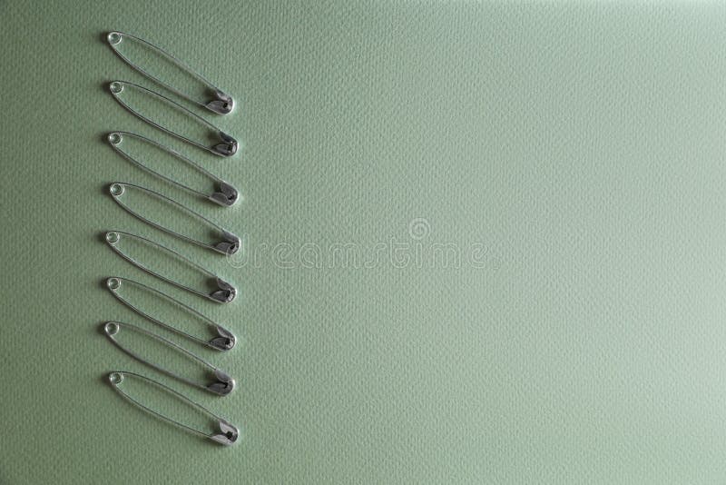 Many Safety Pins on Green Background, Flat Lay. Space for Text Stock ...