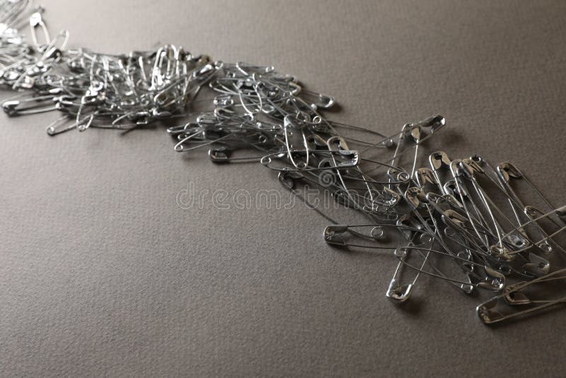 Many Safety Pins on Light Grey Textured Background Stock Image - Image ...