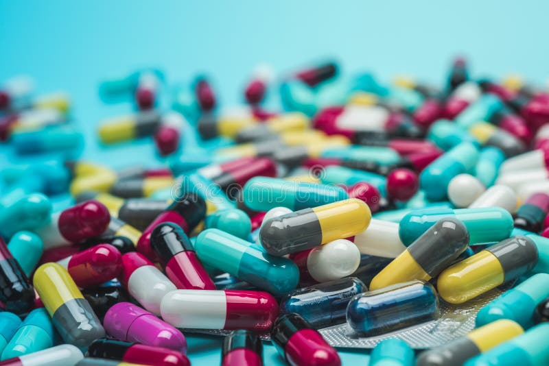 Many Scattered Colorful Pills on Blue Background. Stock Photo - Image ...
