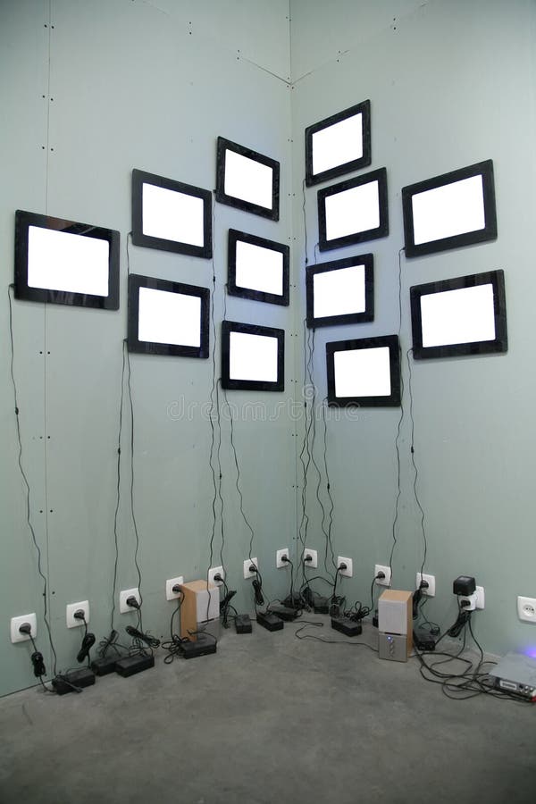 Many screens on wall stock photo. Image of photograph - 4485848