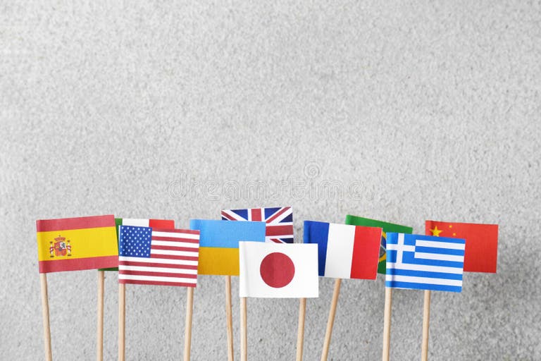 Many Small Paper Flags of Different Countries on Grey Textured Table ...