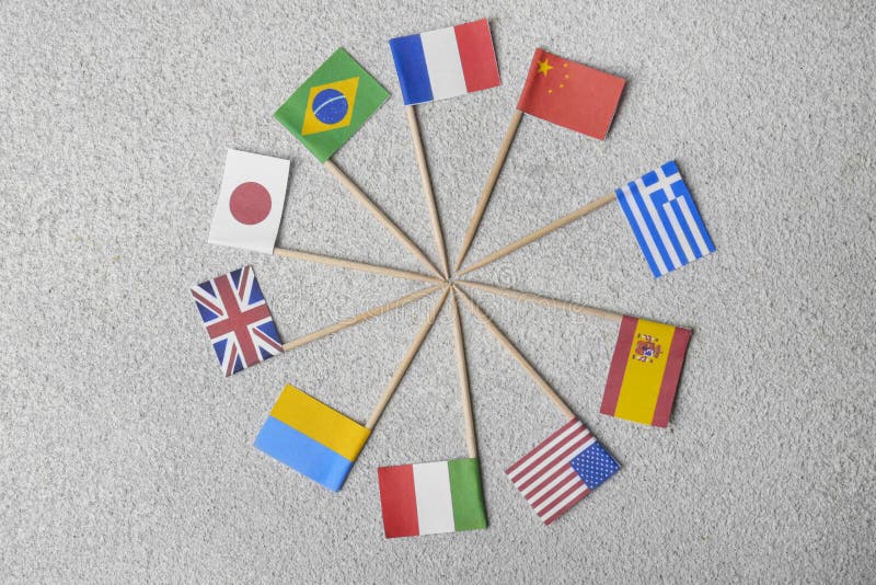 Many Small Paper Flags of Different Countries on Grey Textured Table ...