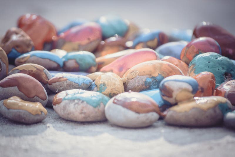 Many Small Pebbles Covered with Multicolored Paint Lie on Surface Stock ...