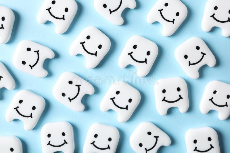 Many Small Plastic Teeth with Cute Faces on Color Background Stock ...
