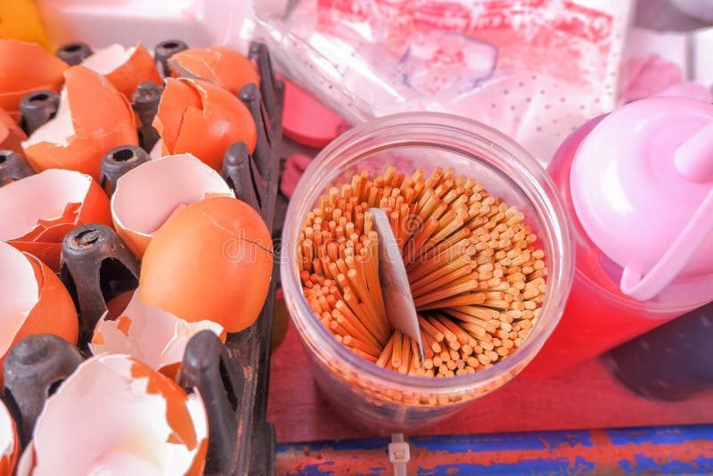 Many Small Sticks are Packed in Plastic Bottles. Placed Next To a Pile ...