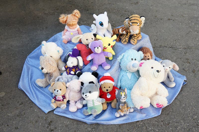 Many Soft Toys on a Blue Blanket. Toys on the Playground Stock Photo ...