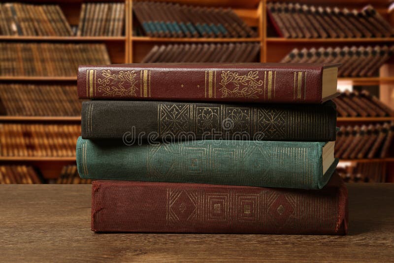 Many Stacked Hardcover Books on Wooden Table in Library Stock Image ...