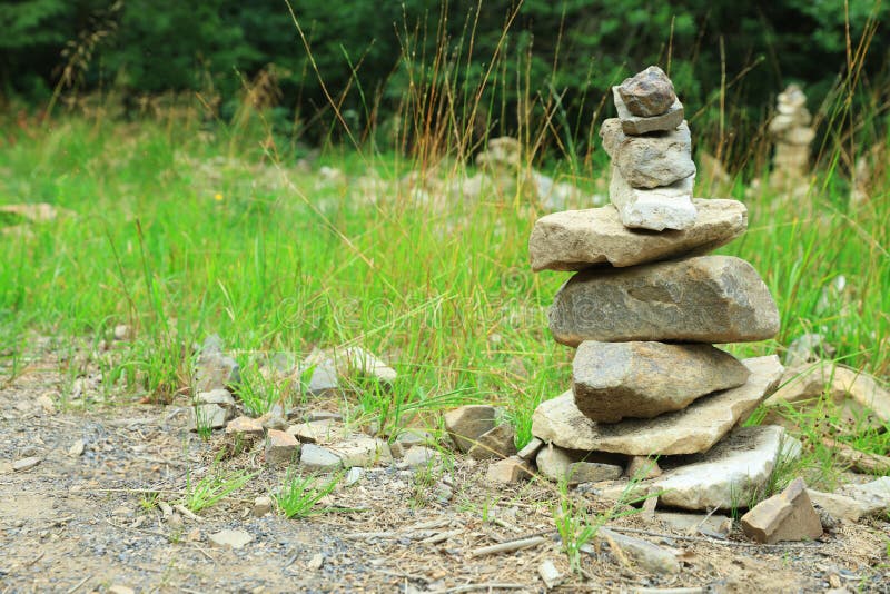 Many Stacked Stones on Green Grass Outdoors, Space for Text Stock Photo ...