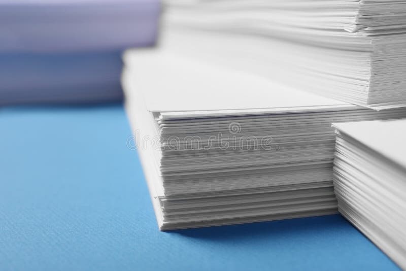 Many Stacks of Paper Sheets on Light Blue Background, Closeup Stock ...