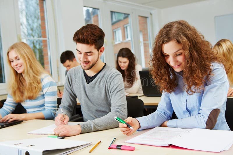 College students in class stock image. Image of notebook - 21324335