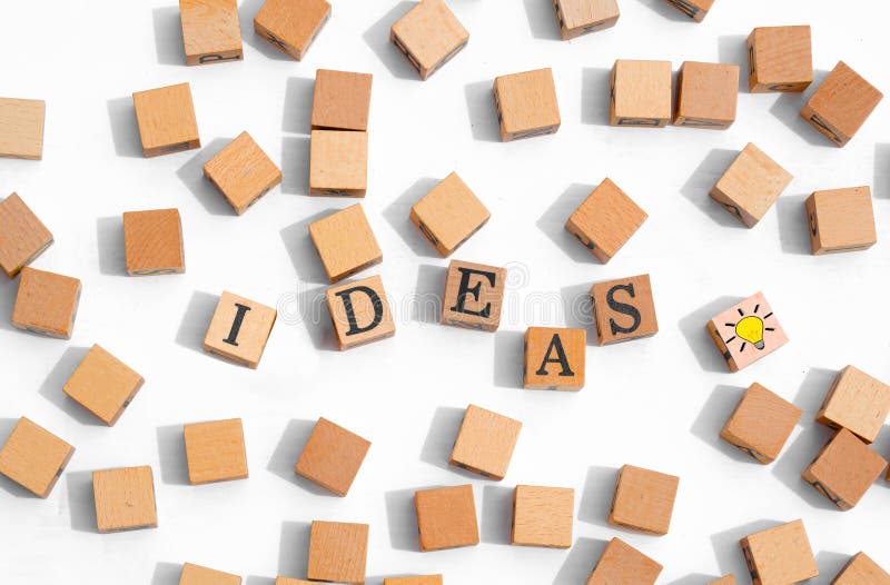 Many Wooden Cubes with "Ideas" Word and Light Bulb Symbol on White ...