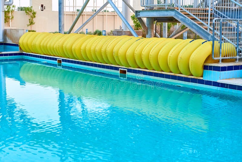 Many Yellow Inflatable Float in Blue Swimming Pool in the Water Park ...