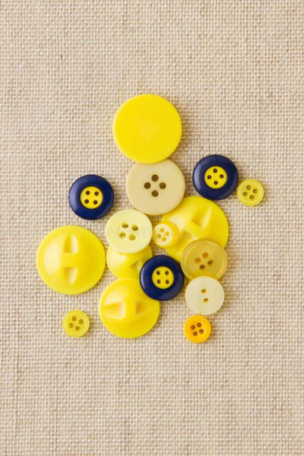 Pile of Yellow Buttons on Hessian Stock Photo - Image of pale ...