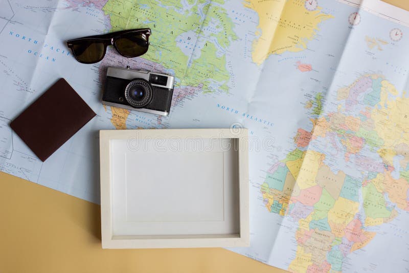 Map with Photo Frame, Camera and Sunglasses Over the Brown Background ...