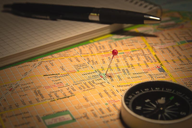 Map with a Red Drop Pin on it Alongside with a Compass, Notebook, and ...