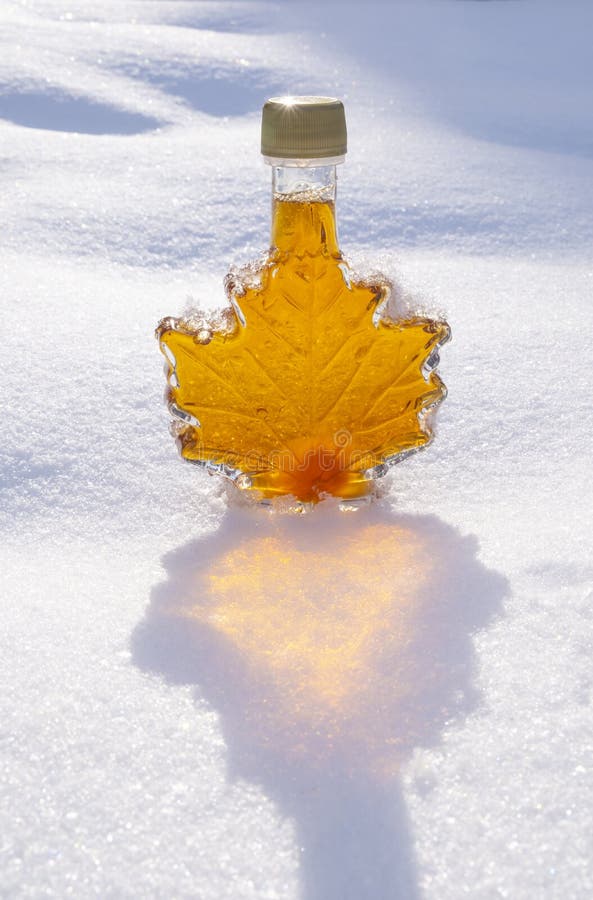 Maple Leaf Shaped Bottle Filled with Golden Maple Syrup Sitting on ...