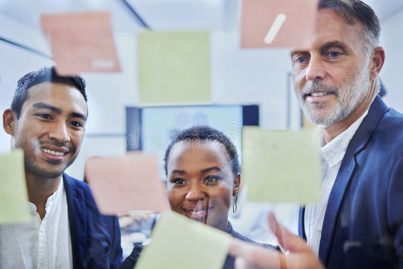 Mapping Out the Way Forward. a Group of Businesspeople Brainstorming in ...