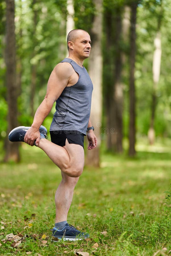 Marathon Runner Stretching and Warming Up Stock Image - Image of effort ...