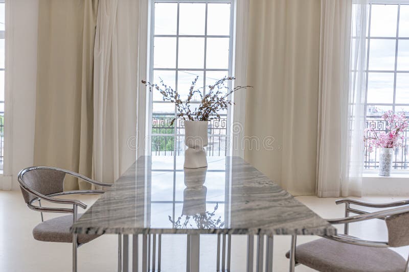 Marble Dining Table and Two Chairs Against the Backdrop of a Panoramic ...
