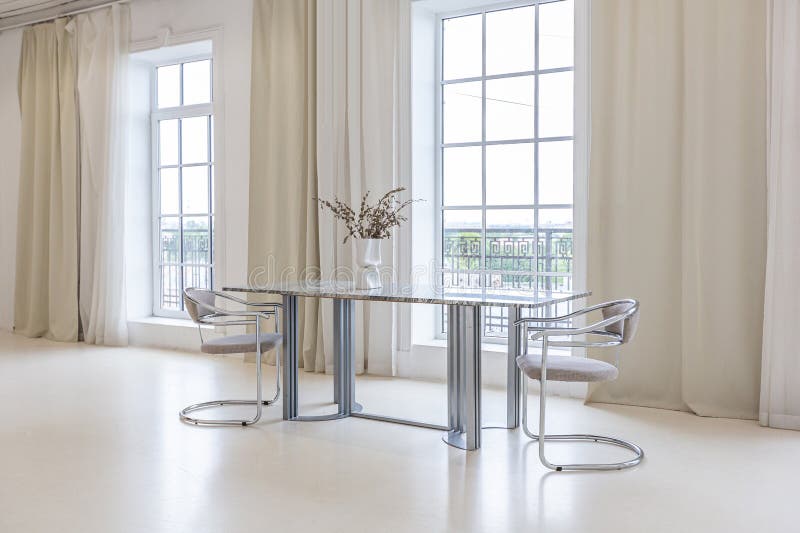 Marble Dining Table and Two Chairs Against the Backdrop of a Panoramic ...