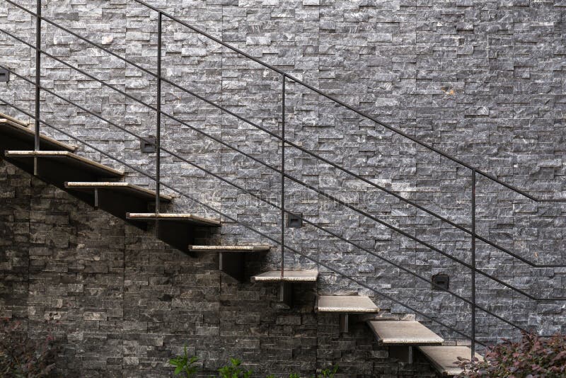 Marble Stairs with Metal Handrail on Granite Wall Stock Image - Image ...