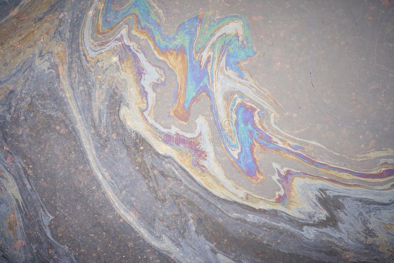 A Marble Texture of a Rainbow Spill of Gasoline on a Sidewalk in a ...