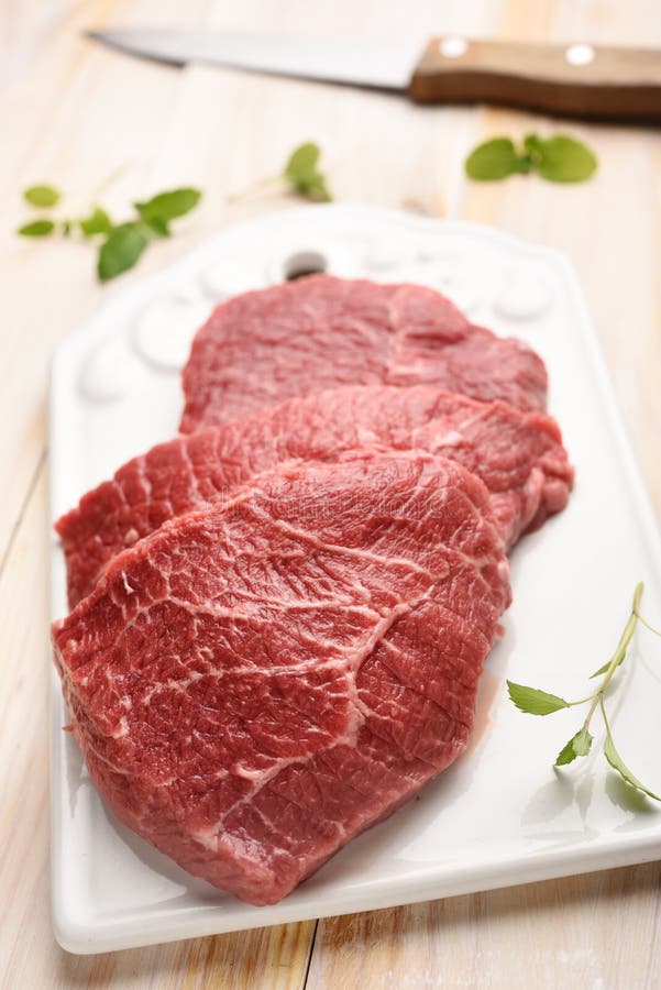 Two Raw Marbled Beef Steaks are Grilled in the Dark in the Evening ...