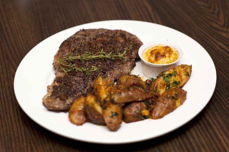 Two Raw Marbled Beef Steaks are Grilled in the Dark in the Evening ...
