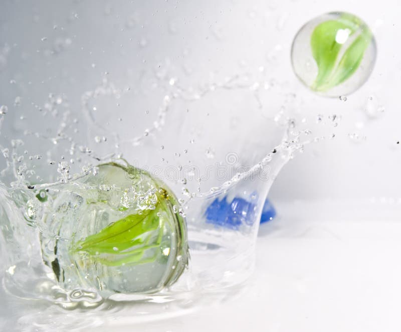 Marbles falling in water. stock photo. Image of water - 4166234