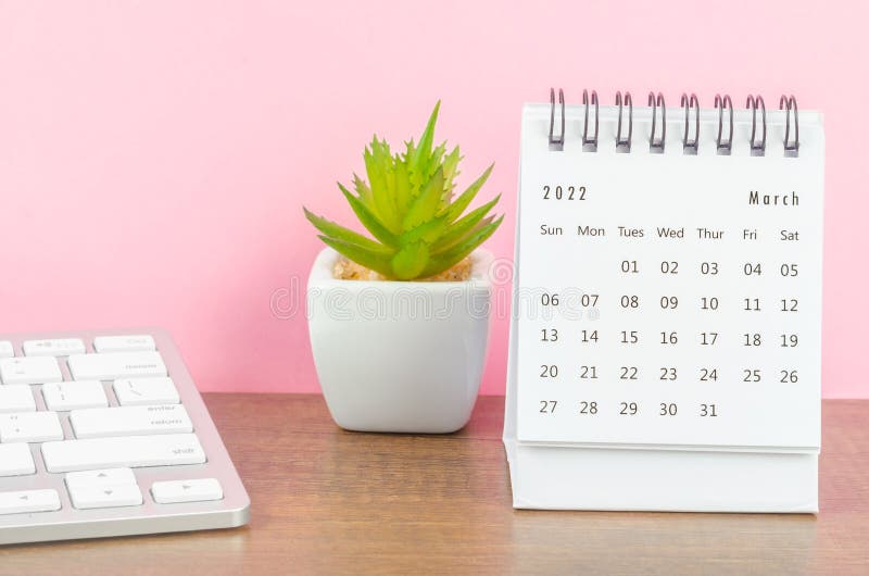 March 2022 Desk Calendar on Wooden Table with Pink Background Stock ...