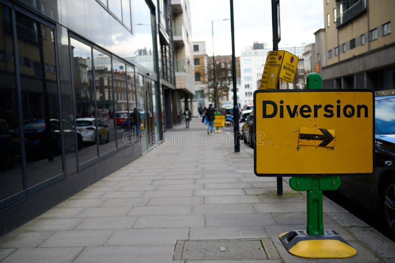 Diversion sign on pavement editorial photo. Image of name - 312264586