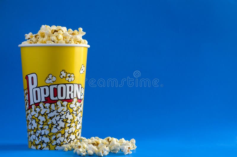 Marco Image of Yellow Popcorn Box with Fresh Popcorn on Blue Background ...