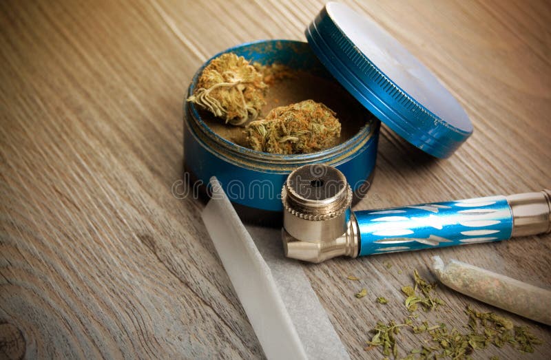 Marijuana Joint and Pipe on Warm Lighted Table Stock Photo - Image of ...