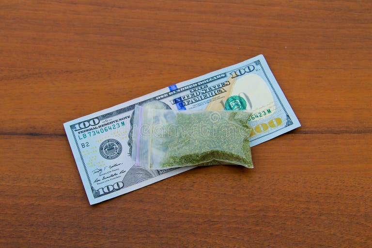 Marijuana in Packet and 100 Dollar Bill on Wooden Table Stock Image ...