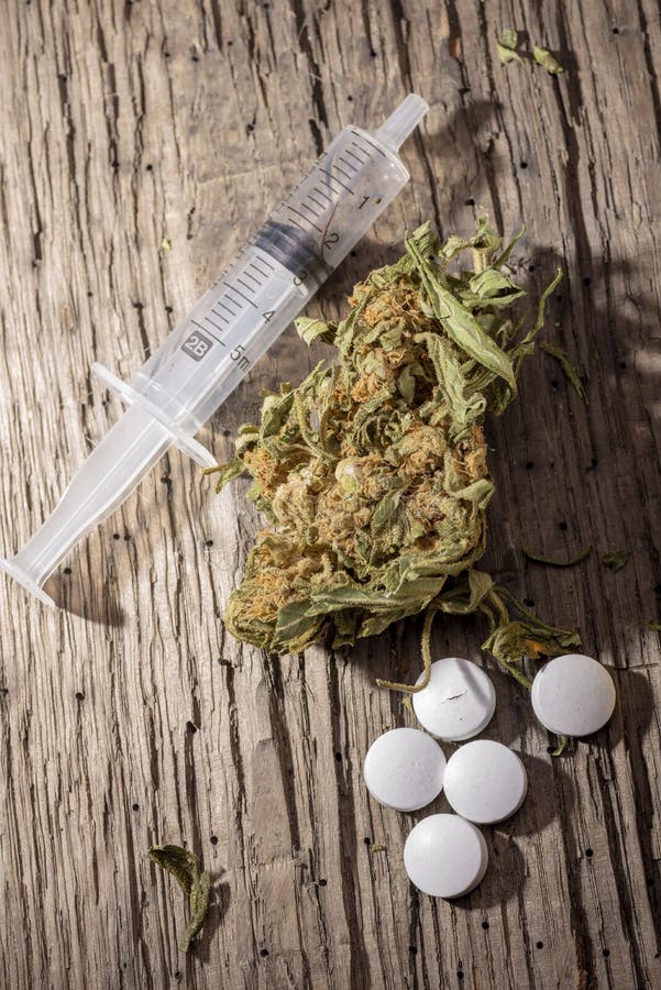 Marijuana and Syringe on a Background of Bog Oak 2019 Stock Photo ...