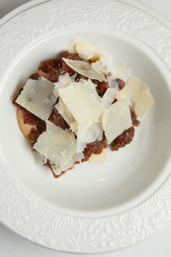 Marinated Fish Tar Tar with Parmesan Cheese on a White Plate Stock ...