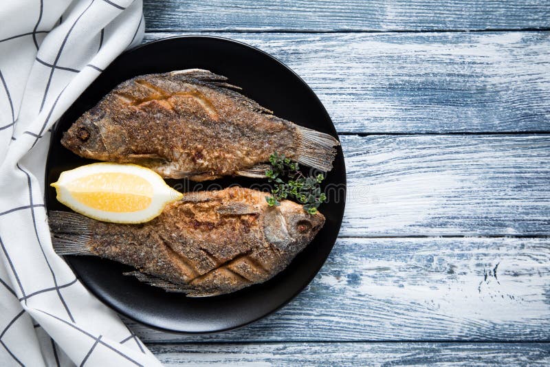 Marinated Fried Fish Carp. Spicy Fish Fry with Spices and Lemon Stock ...