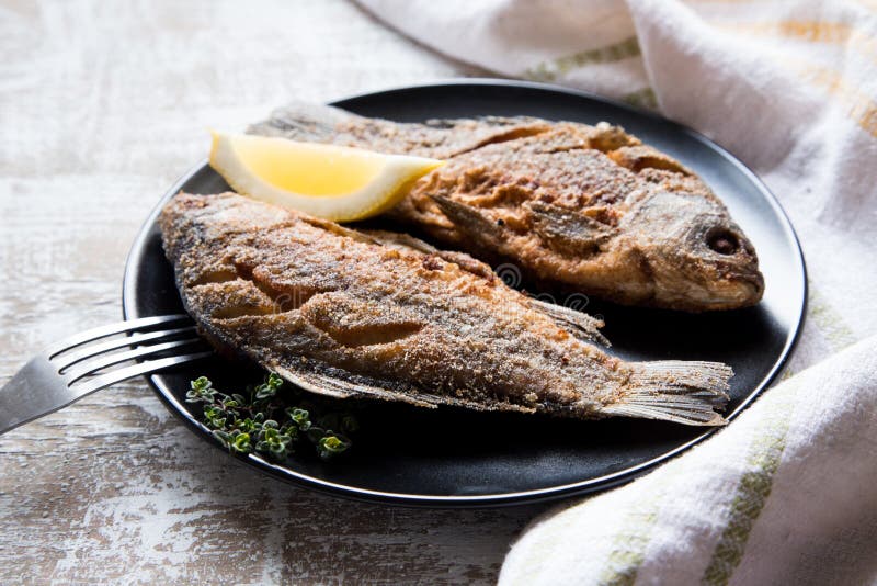 Marinated Fried Fish Carp. Spicy Fish Fry with Spices and Lemon Stock ...