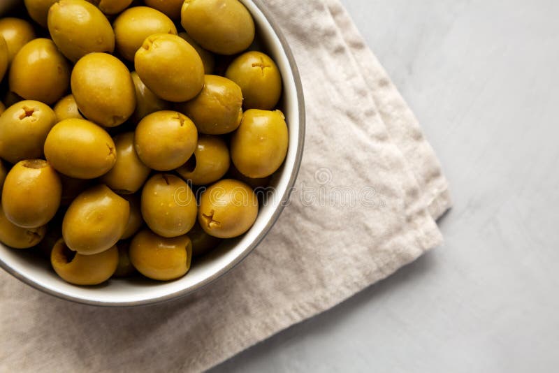 Green Pitted Olives in a White Plate. Olives Close-up Top View Stock ...