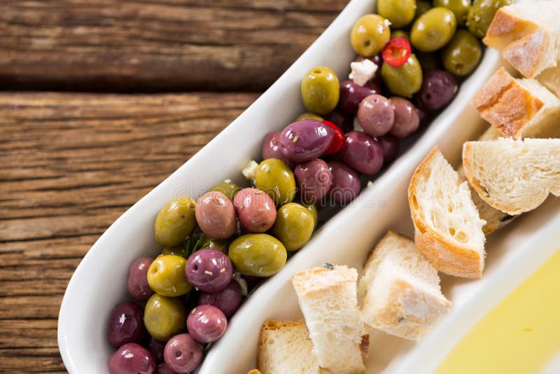 Marinated Olives, Bread Pieces and Olive Oil in Platter Stock Photo ...