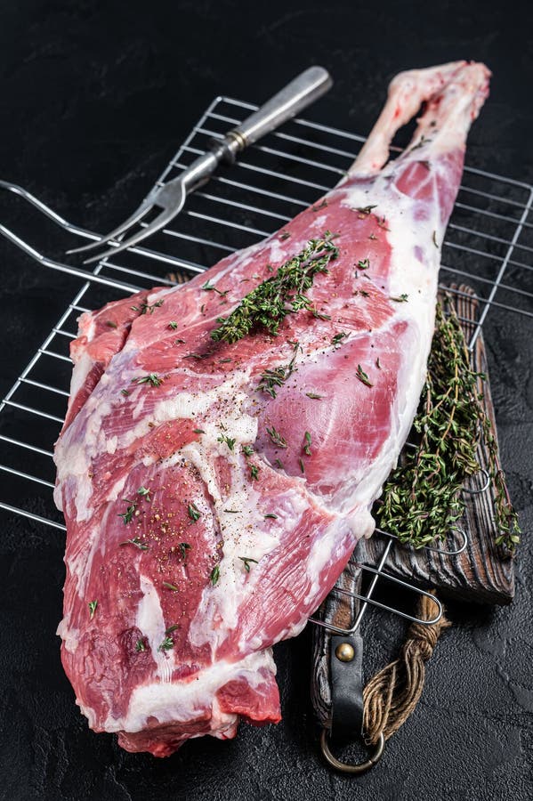 Raw Lamb Leg with Spices and Herbs on Marble Cutting Board. Dark ...