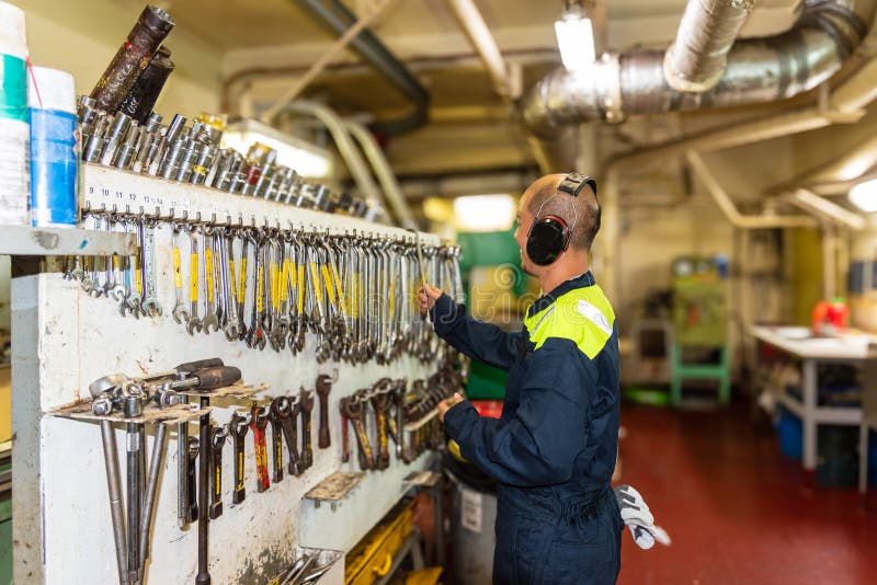 A Marine Engineer Stands in the Engine Room Workshop. Stock Image ...