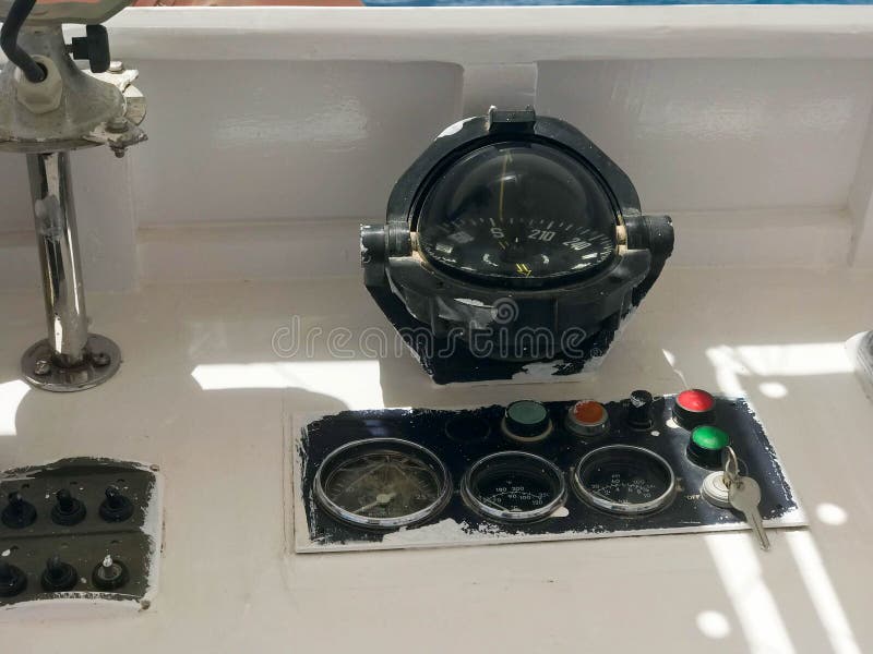 A Marine, Ship`s Black Round Compass, and an Instrument Panel with a ...