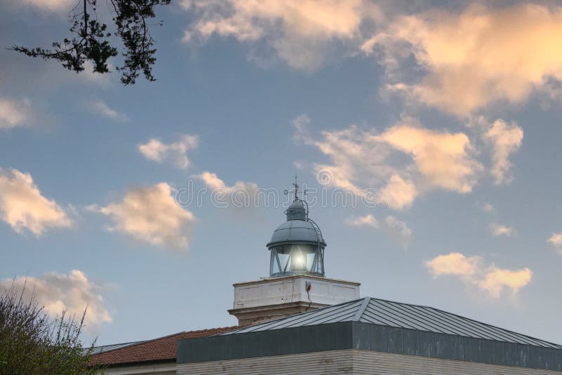 Maritime Lighthouse Lit with Sunset Sky Stock Image - Image of maritime ...