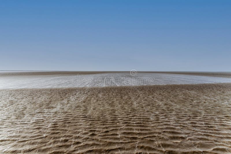 Maritime Mudflat Landscape with Reflection of Clouds in Low Tide Water ...