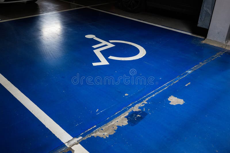Blue Parking Spot with Accessibility Symbol in a Parking Garage Stock ...