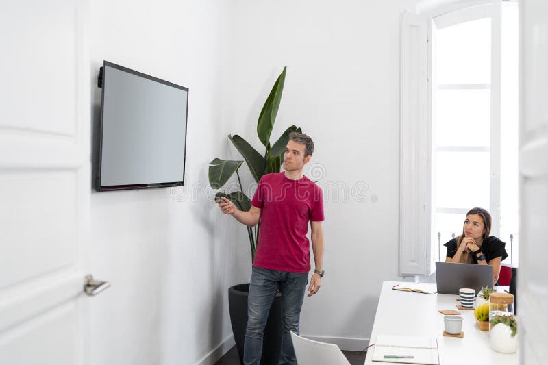 Marketing Professional Giving Presentation Using Tv Screen in Modern ...