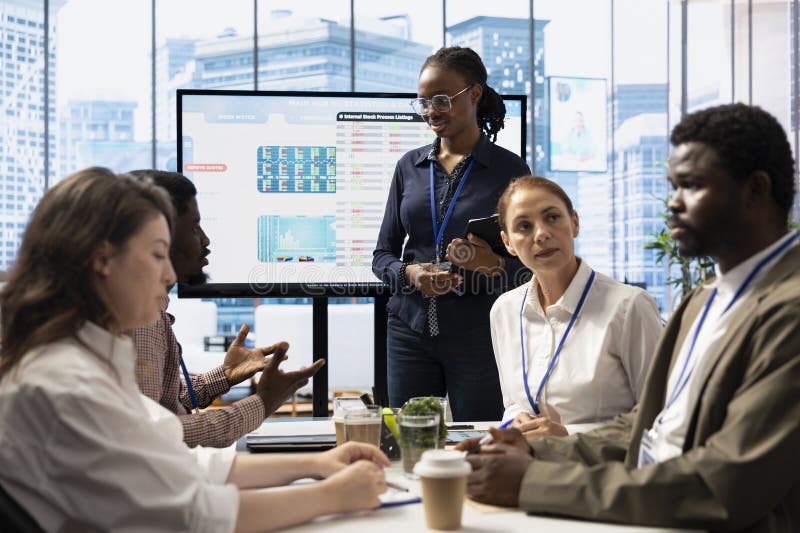 Marketing Specialist Showing Infographics in a Status Update Meeting ...