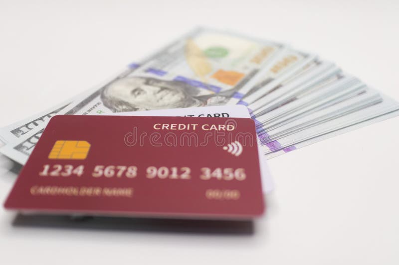 Maroon Credit Card on Stack of US Dollar Banknotes . Stock Image ...