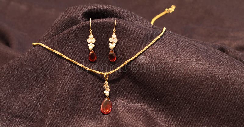 Maroon Jewelry Set in Black Background Stock Photo - Image of metallic ...